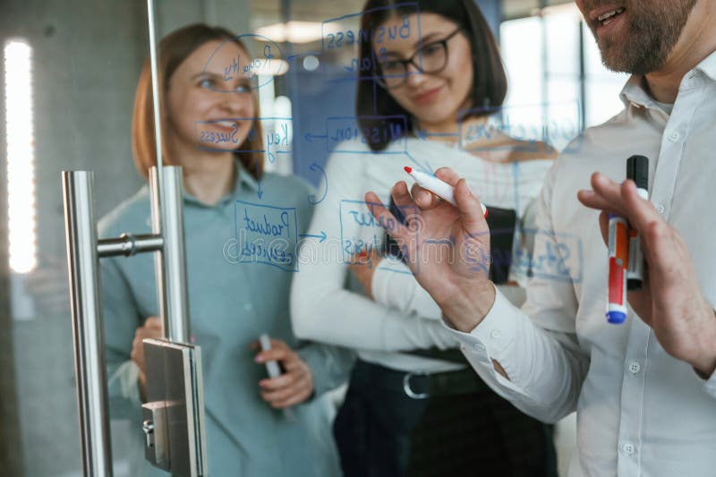 Blue Color Text. Office Workers are Creating Plan, Standing by Glass ...
