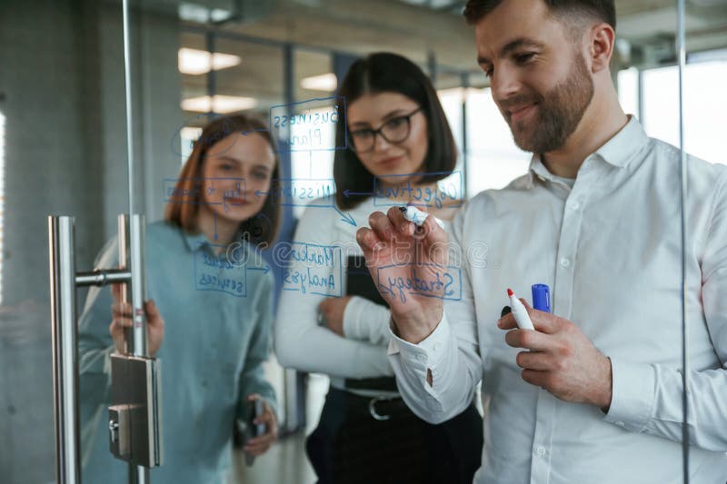 Blue Color Text. Office Workers are Creating Plan, Standing by Glass ...