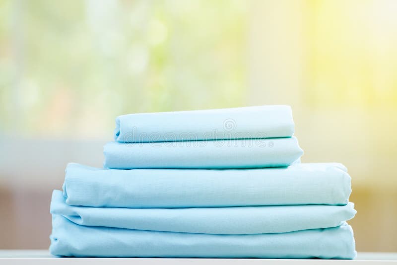 Blue Colored Bedding on a Blurred Background. Stack of Folded New ...