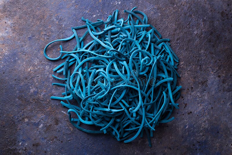 Blue Colored Pasta with Shrimps, Cherry Tomatoes and Zucchini on Dark ...