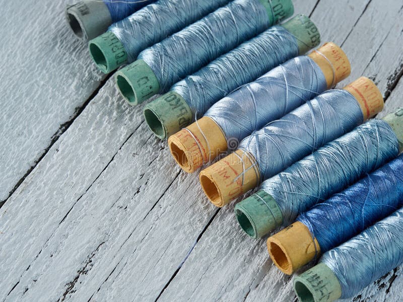 Blue and Colored Silk Threads on Paper Sleeves.Vintage Threads Lie on a ...