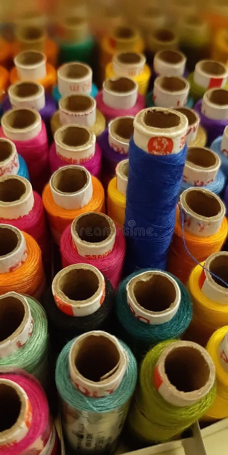 Blue Colored Thread Reel between Multi Colored Thread Reels . Stock ...