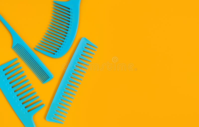 Blue Combs on a Yellow Background. Copy Space. View from Above. Stock ...