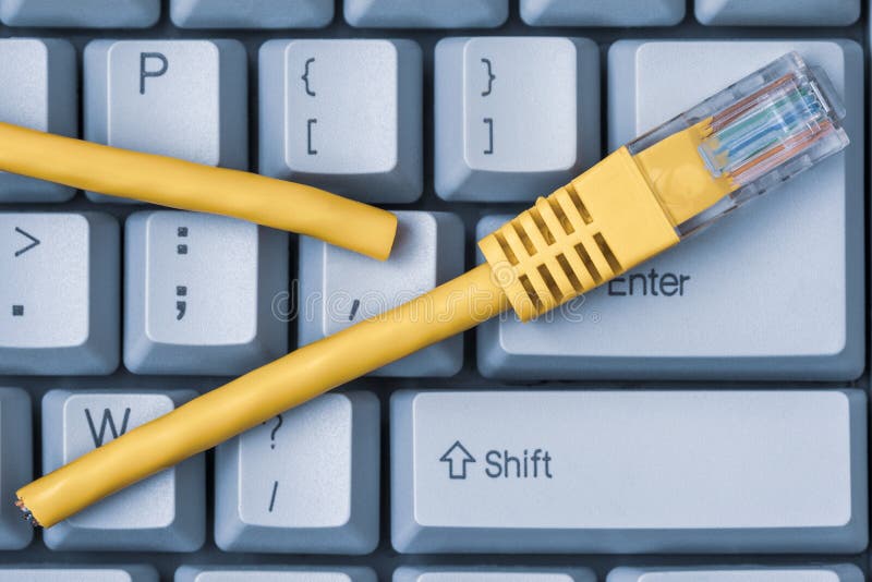 Blue Computer Keyboard With Yellow Network Cable Cutted Off Stock Image