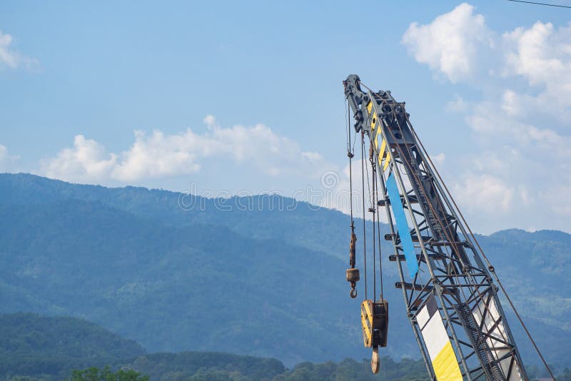 Blue Construction Crane on Bule Sky and Mountains Background Stock ...