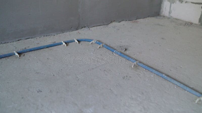 Corrugated Plastic Pipe Installed on Concrete Floor with Clips during ...