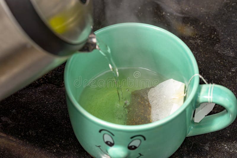 Blue Cup with Drawing of a Smiling Figure with Water and Tea Bag Stock ...