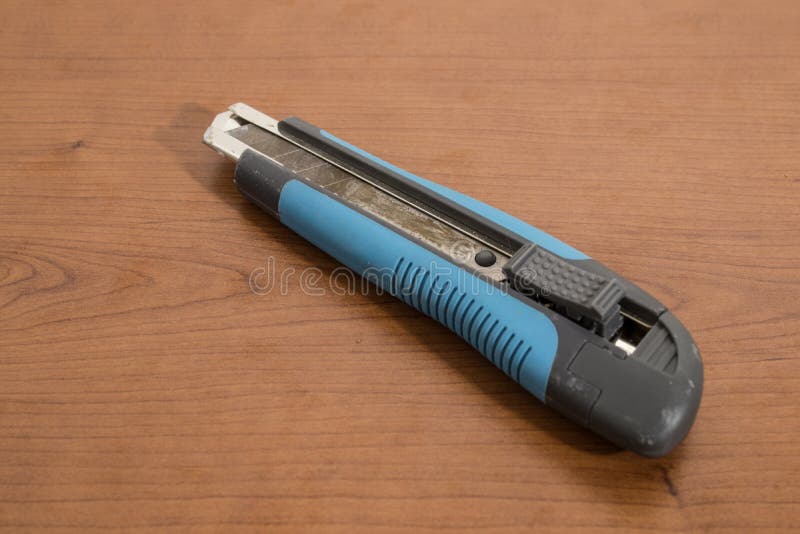Blue Cutter Blade on a Wood Table Stock Image - Image of cutter, tool ...