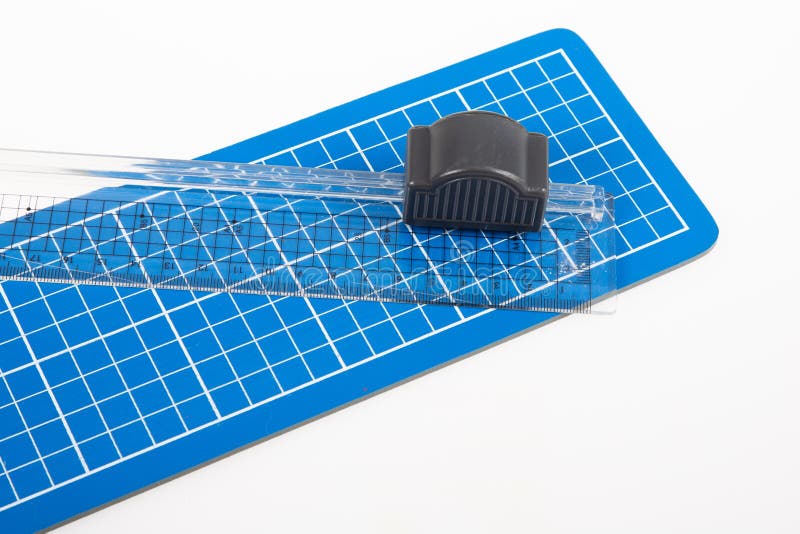 Blue Cutting Mat and Rule Cutter on a White Background Stock Image ...