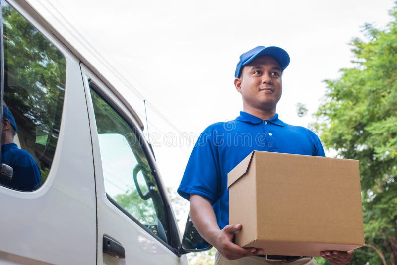 Blue Delivery Man Holding Parcel Cardboard Box Stock Photo - Image of ...