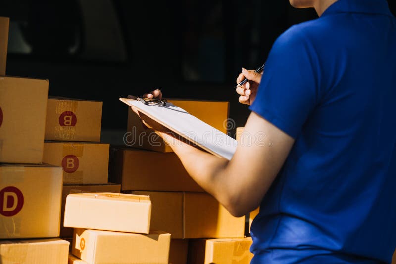 Delivery Man with Cardboard Box Checking Document List in Van and ...