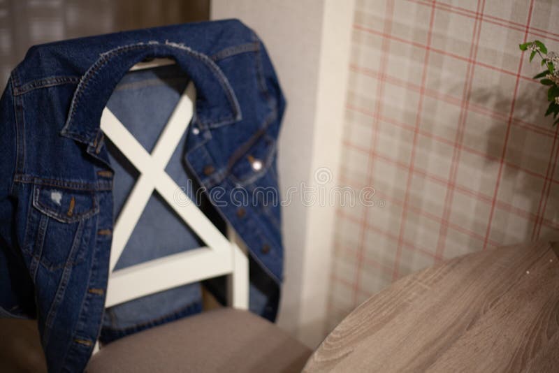 Denim jacket on a chair stock photo. Image of cagen - 181067708