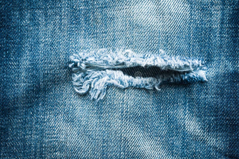 Blue denim jeans with tear stock image. Image of space - 58080595