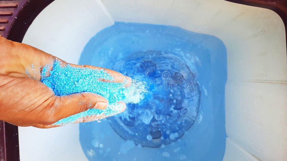 Blue Detergent Powder in Hands and Adding it in Water in Washing Stock ...