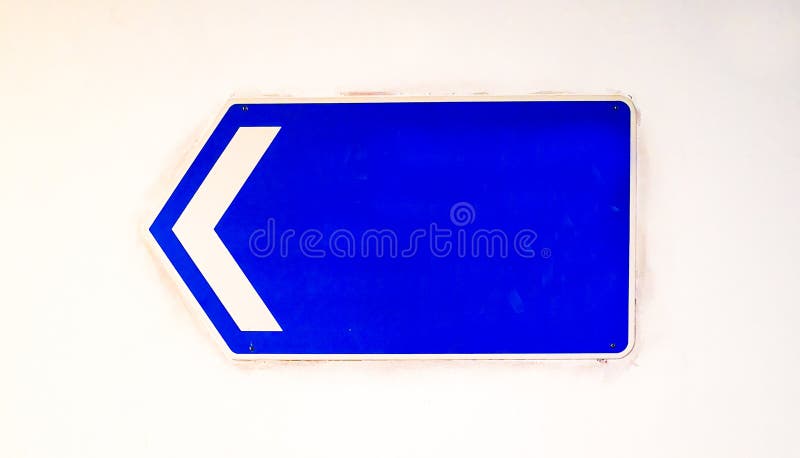 Blue Directional Arrow Sign on Traffic Bollard before a Crosswalk ...