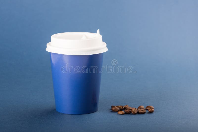 Blue Disposable Cup with White Cap and Coffee Beans on a Blue ...