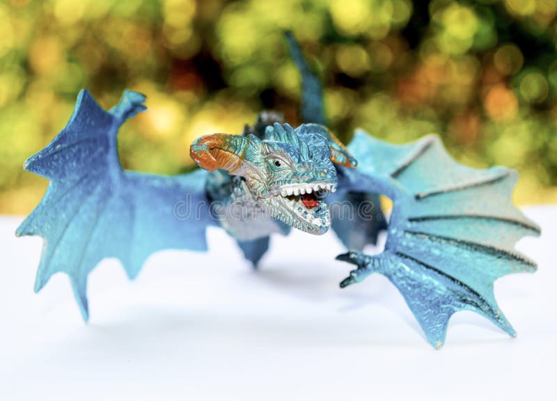 Blue Dragon Flying with Green Bokeh Background Stock Photo - Image of ...