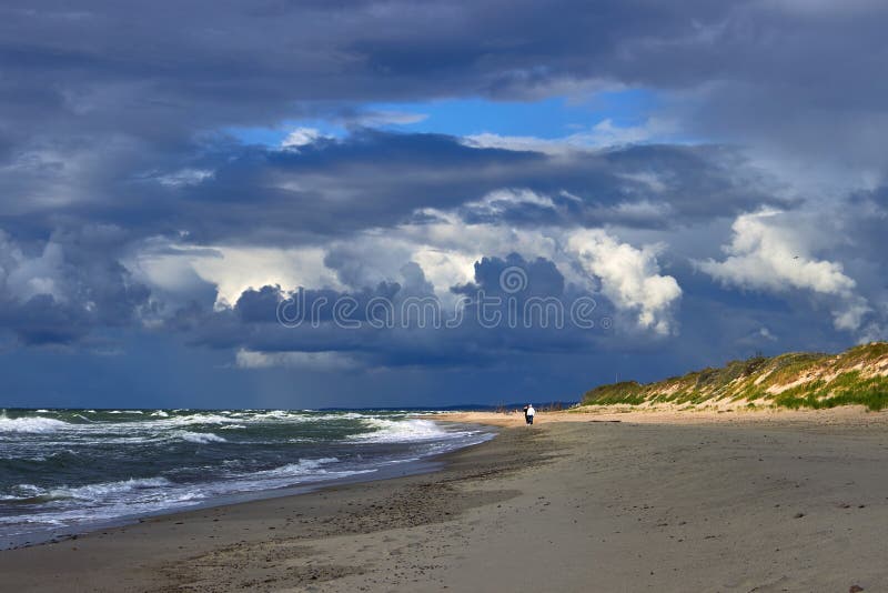 Blue Dramatic Clouds and Sunbeams Break through Over the Beach Stock ...