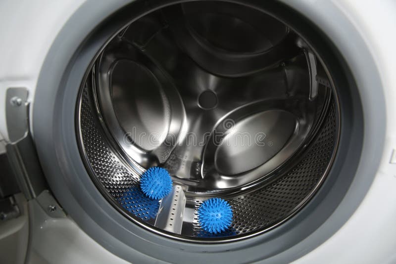 Blue Dryer Balls in Washing Machine Drum, Closeup Stock Image - Image ...