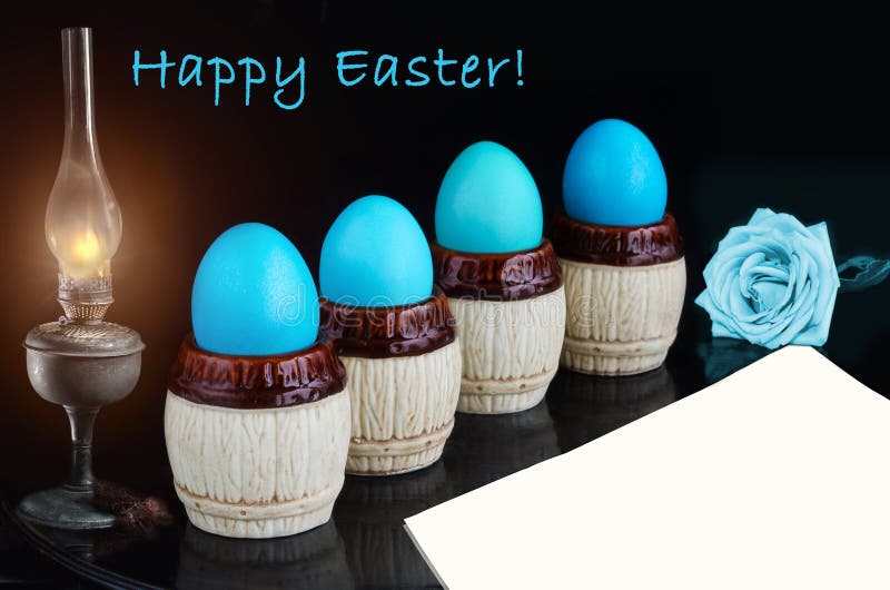 Blue Easter Eggs, a Lit Old Lamp and a Blank Sheet of Paper on a Black ...