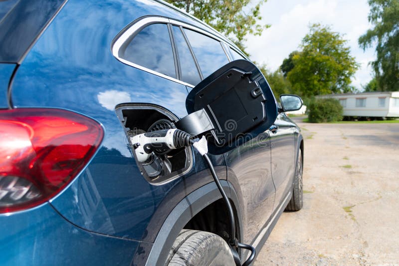 Blue EV Plug in Battery Electric Car on Charge with a Granny Cable at ...