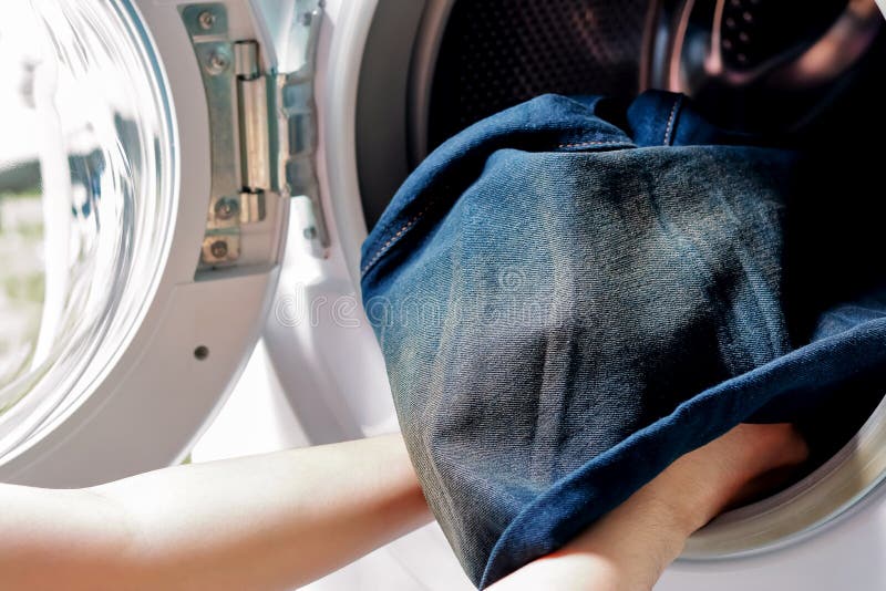 Blue Fabric Jeans Loading into Washing Machine by Hand for Clean Stock ...