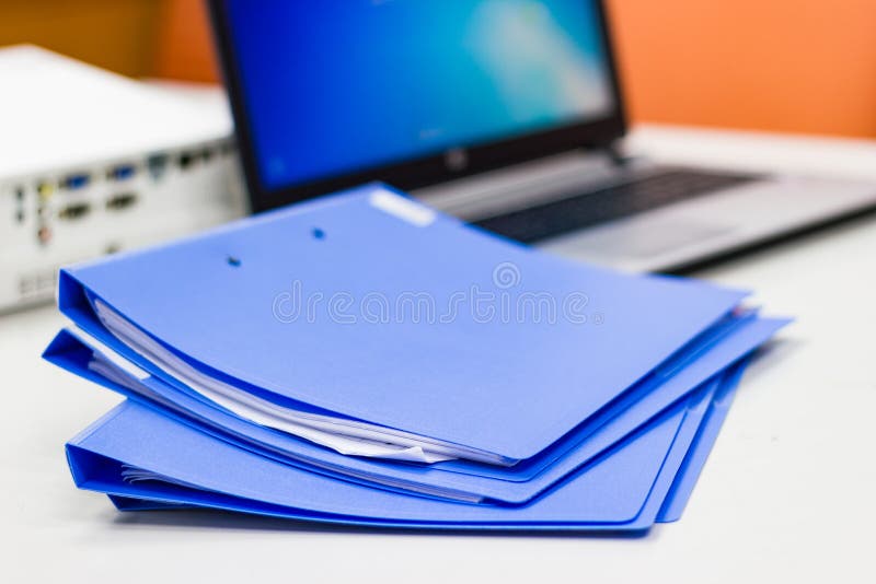 Blue File Folder with Documents and Notebook on the White Table Stock ...
