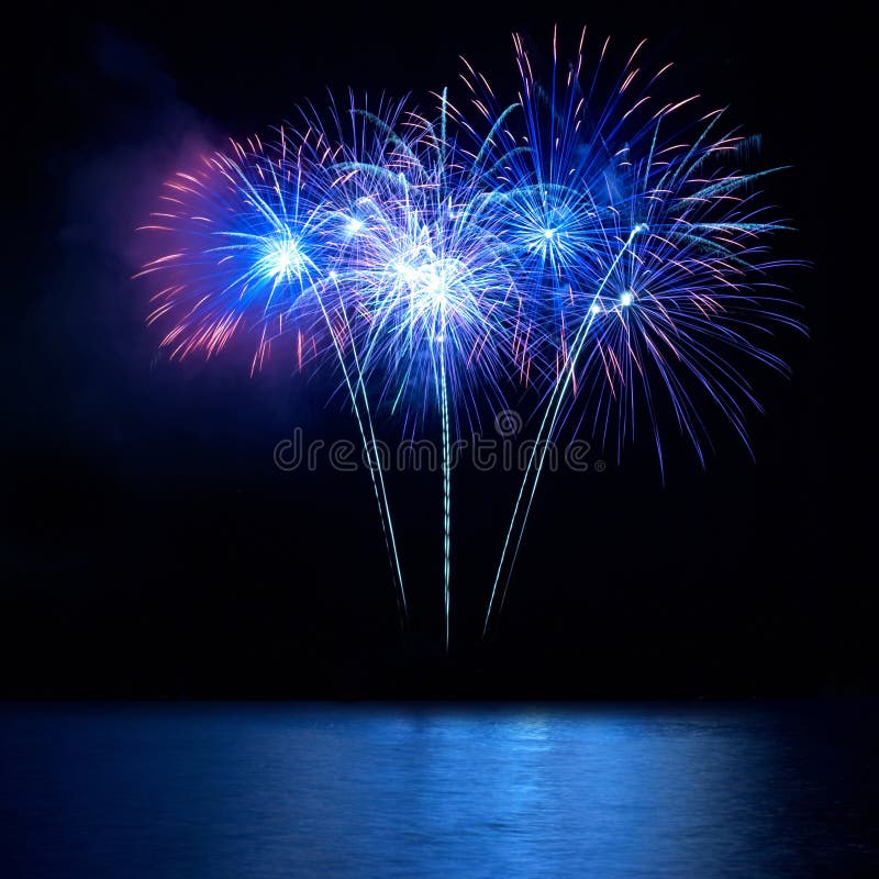 Blue fireworks above water stock image. Image of abstract - 63161111