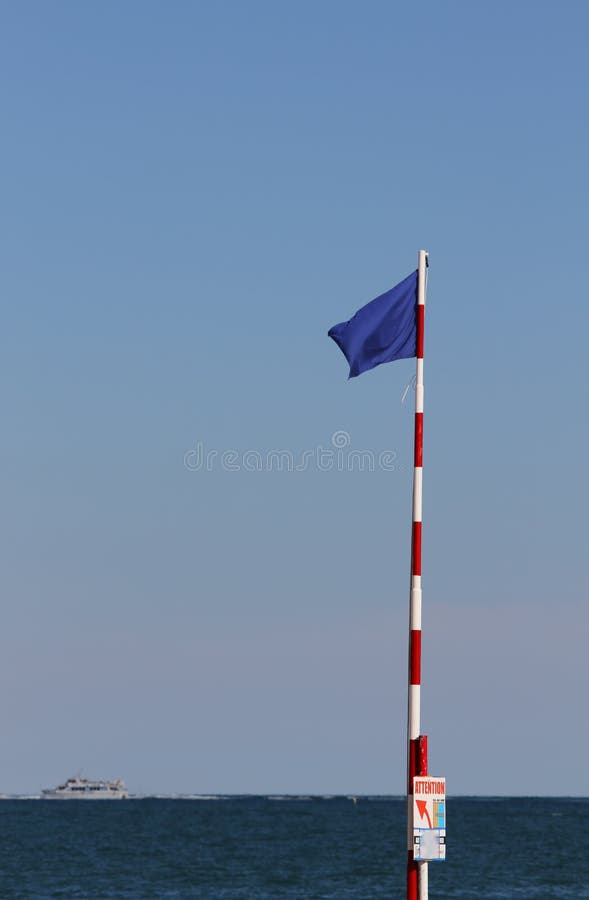 Blue flag near the ocean stock photo. Image of summer - 42737958