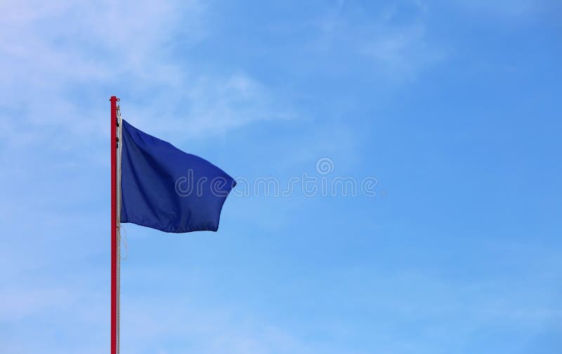 Blue Flag Waves on the Blue Sky with Few Clouds Stock Photo - Image of ...