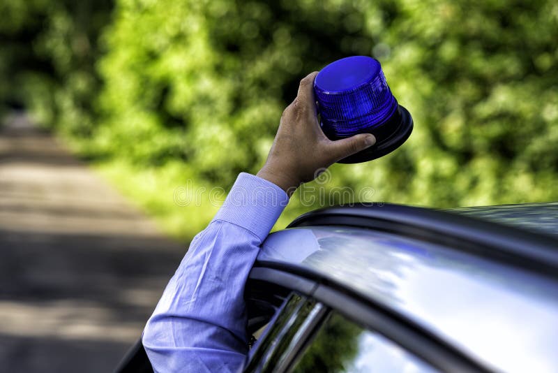 Blue Flashing Light on a Police Car Stock Photo - Image of plainclothes ...