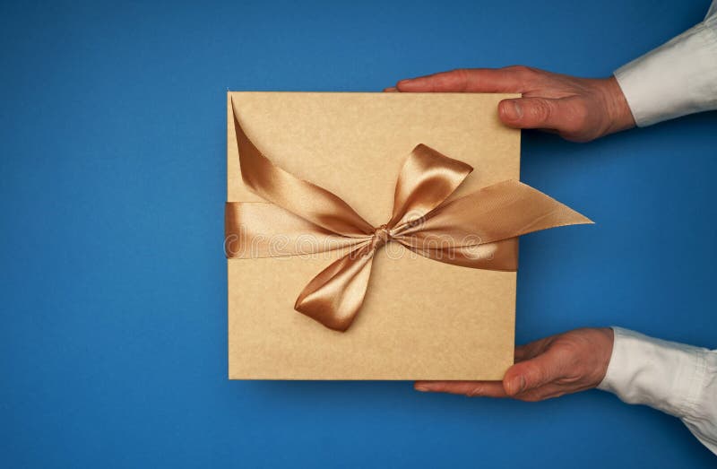 On a Blue Flat Background Hands Pass a Yellow Gift Stock Photo - Image ...
