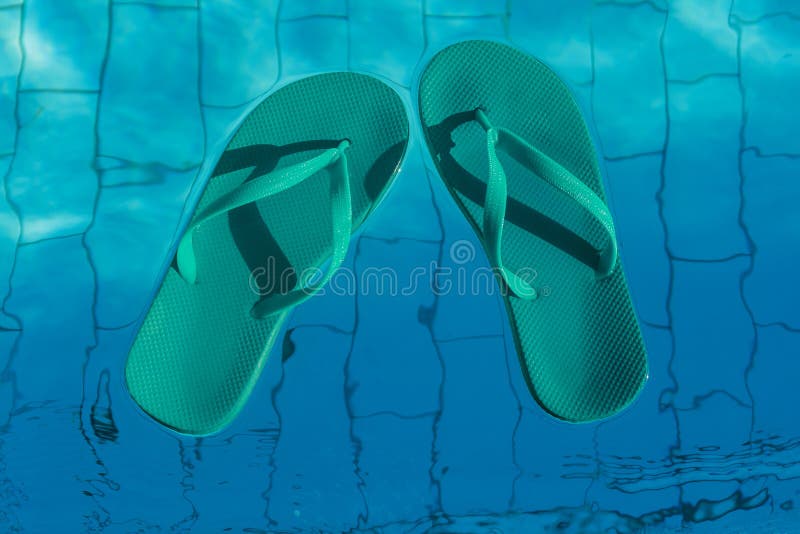 Blue Flip-flops Floating in a Swimming Pool, a Top View Stock Photo ...