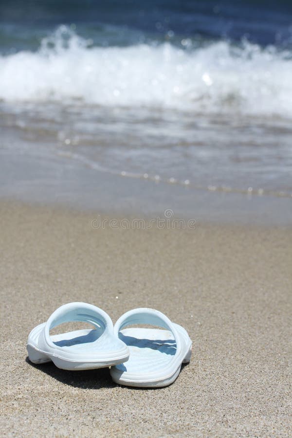 Blue Flip Flops on Sand Beach in Front of Sea Wave Stock Image - Image ...