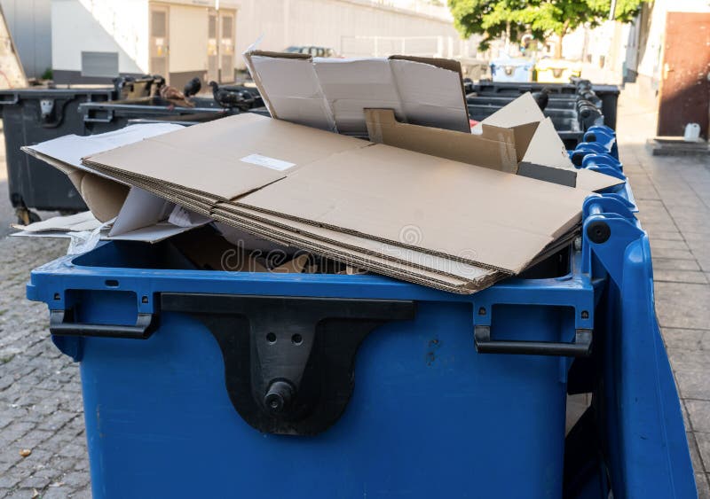 Blue Garbage Bin with Cardboard in it in the City. Separate Waste ...