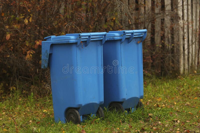 Blue Garbage Cans on the Sidewalk Stock Image - Image of pavement ...