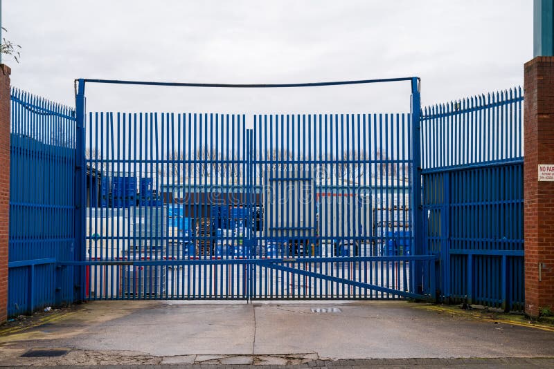 Blue Gates To the Entrance of a Warehouse with a Red Brick Wall Stock ...