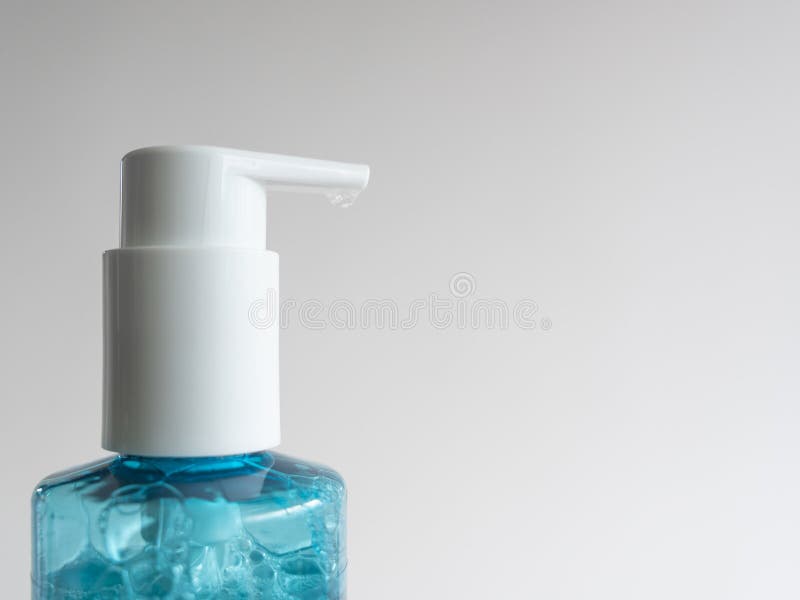 Blue Gel Dispenser Bottle with Bubbling Contents and a Drop of Soap on ...