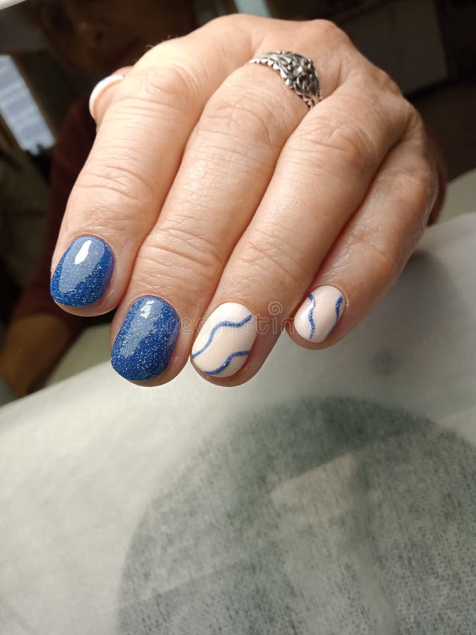 Blue gel nail polish stock image. Image of manicure - 260588393