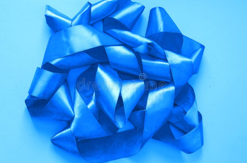 Blue Satin Ribbon for Gift Wrapping on a Blue Background. Stock Photo ...