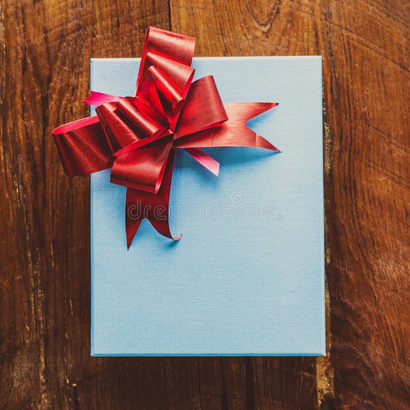Blue Gift Box with Red Ribbon on Wood Stock Photo - Image of brightly ...