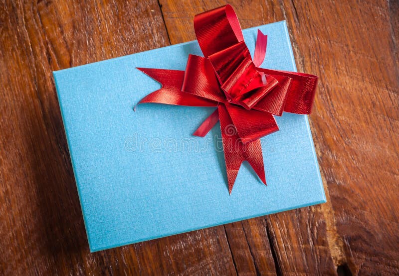 Blue Gift Box with Red Ribbon on Wood Stock Photo - Image of brightly ...