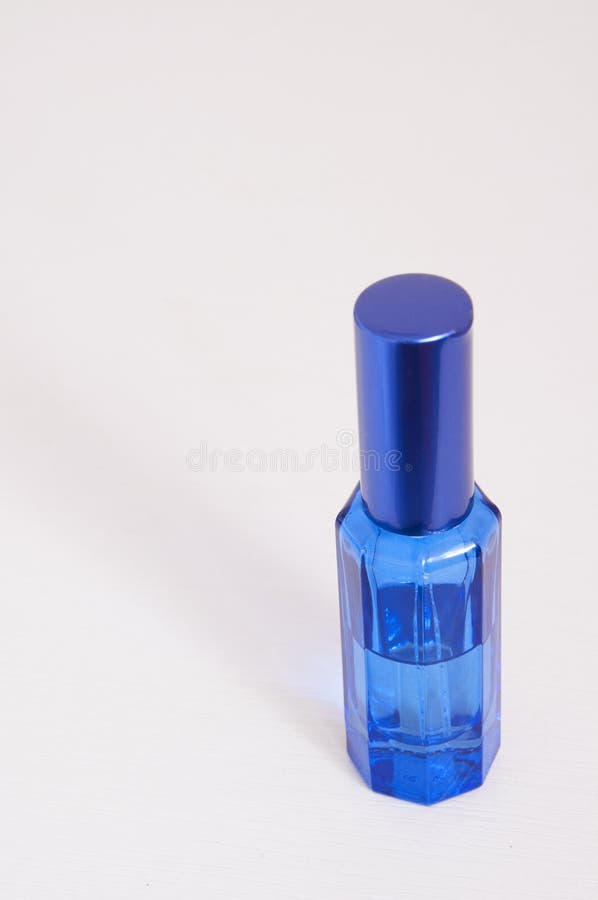 Blue Glass Bottle with a Blue Cap. on a White Table. Perfumes and ...