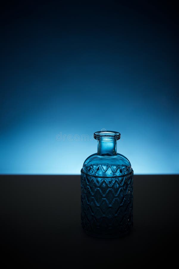 Blue Glass Bottle on a Table Table Stock Photo - Image of antique ...