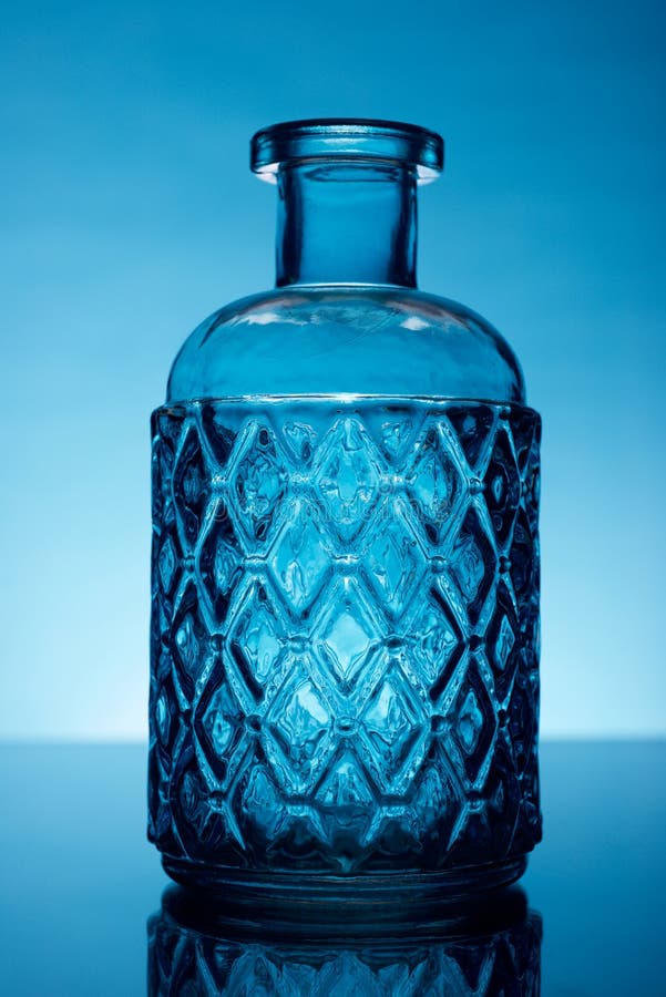 Blue Glass Bottle on a Table Table Stock Photo - Image of gift, blue ...