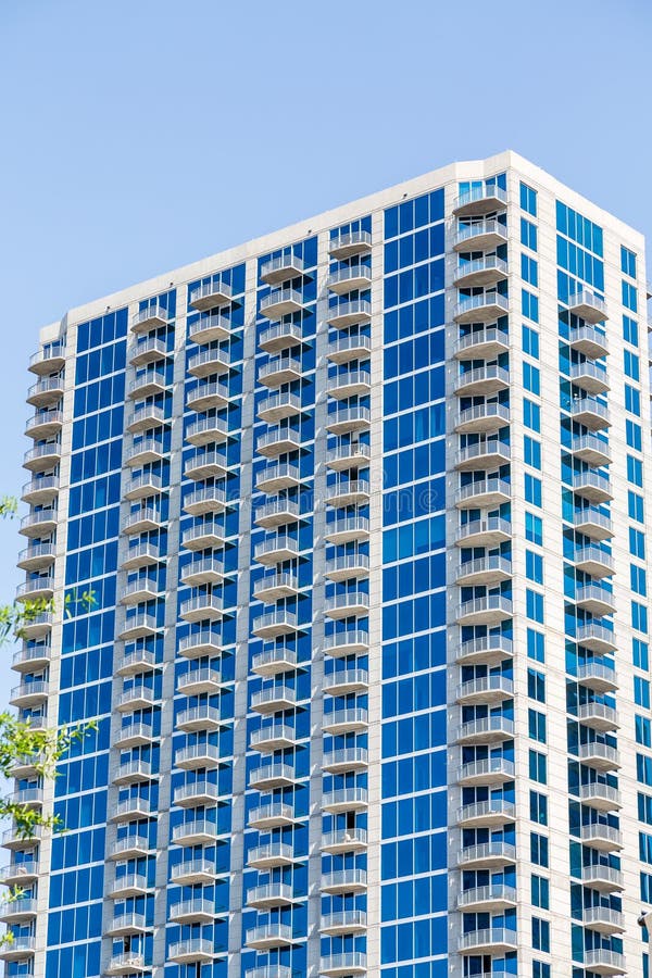 Blue Glass Condo Tower with White Balconies Stock Image - Image of ...