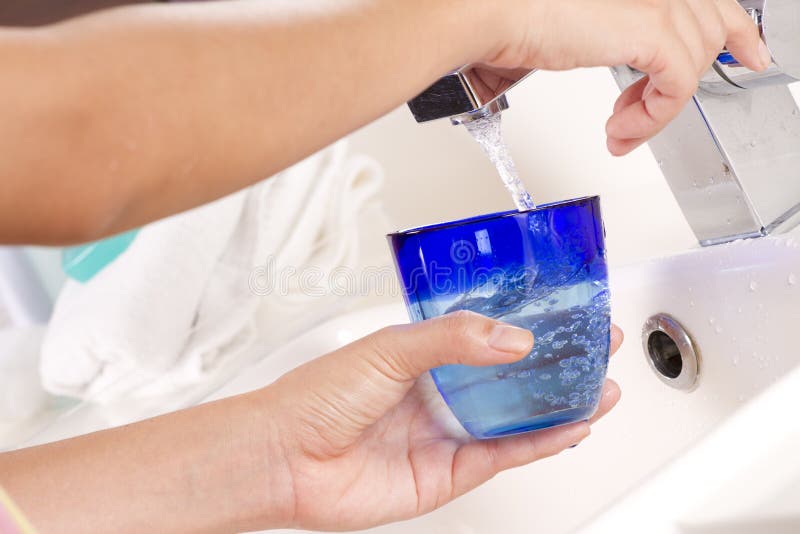 Blue glass and faucet stock image. Image of faucet, hygienic - 29024451