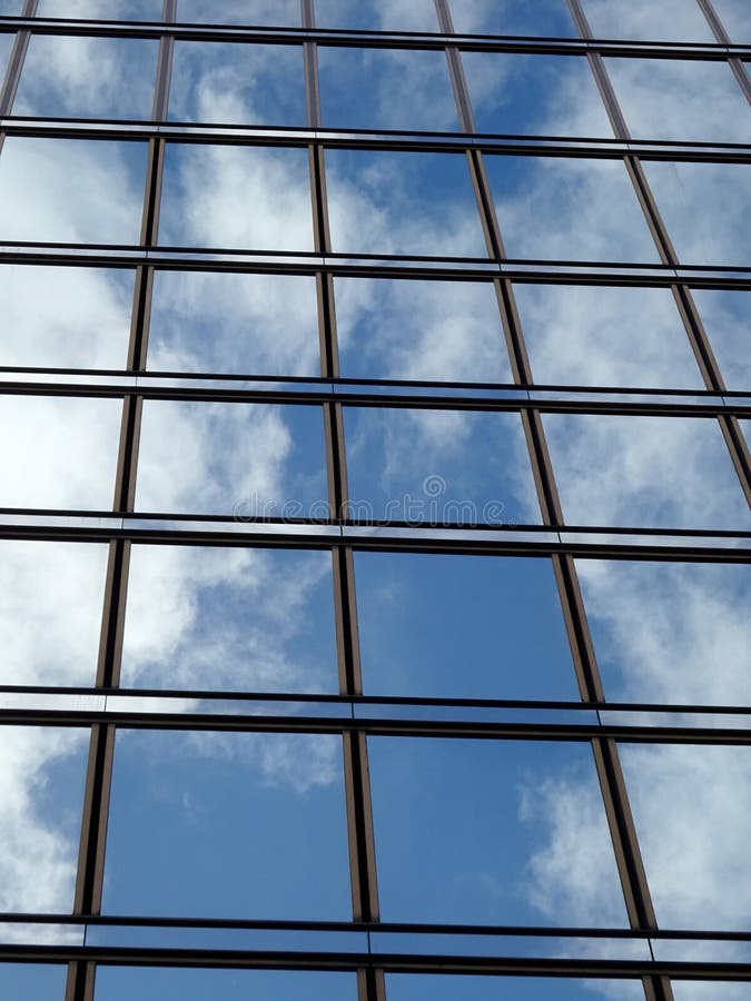 Blue Glass Windows Reflect Clouds and Sky Stock Image - Image of grid ...