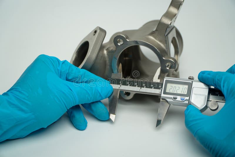 Blue Gloved Hand of Engineer Measuring Metal Parts with Digital Vernier ...