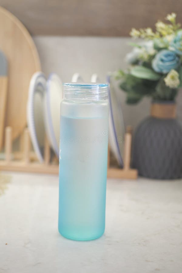 Blue Gradient Bottle on Kitchen Counter with Dishes Stock Photo - Image ...